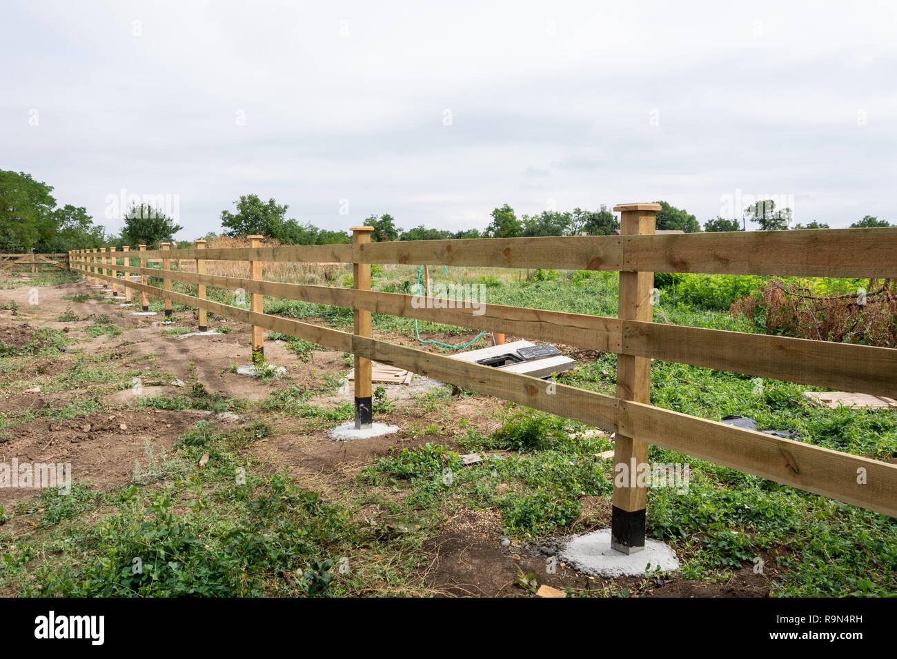 The base of the wooden fence. Fence ranch style details Stock Photo - Alamy
