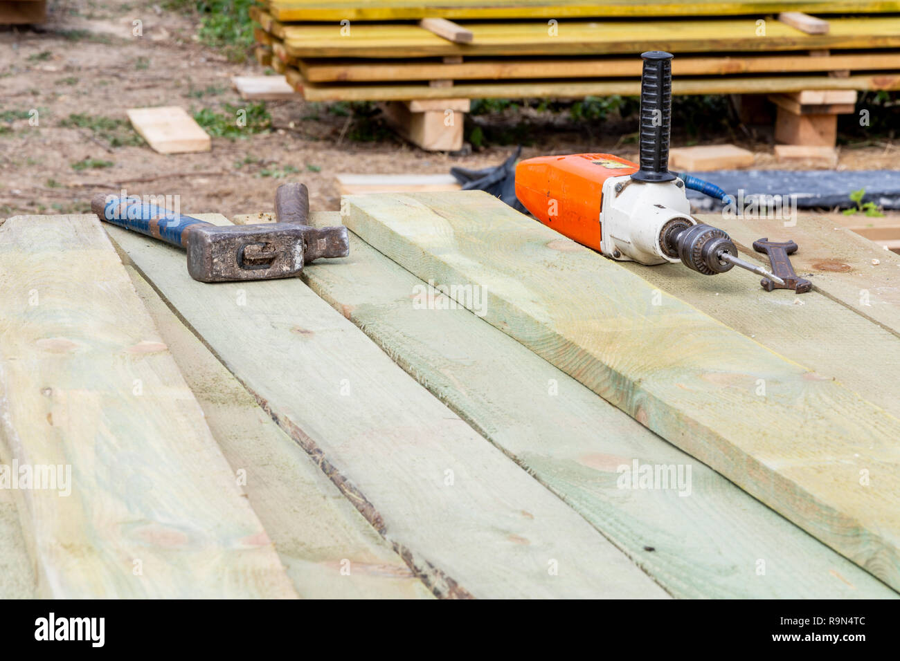 Drill, hammer and wrench on a construction site. Building tools Stock ...