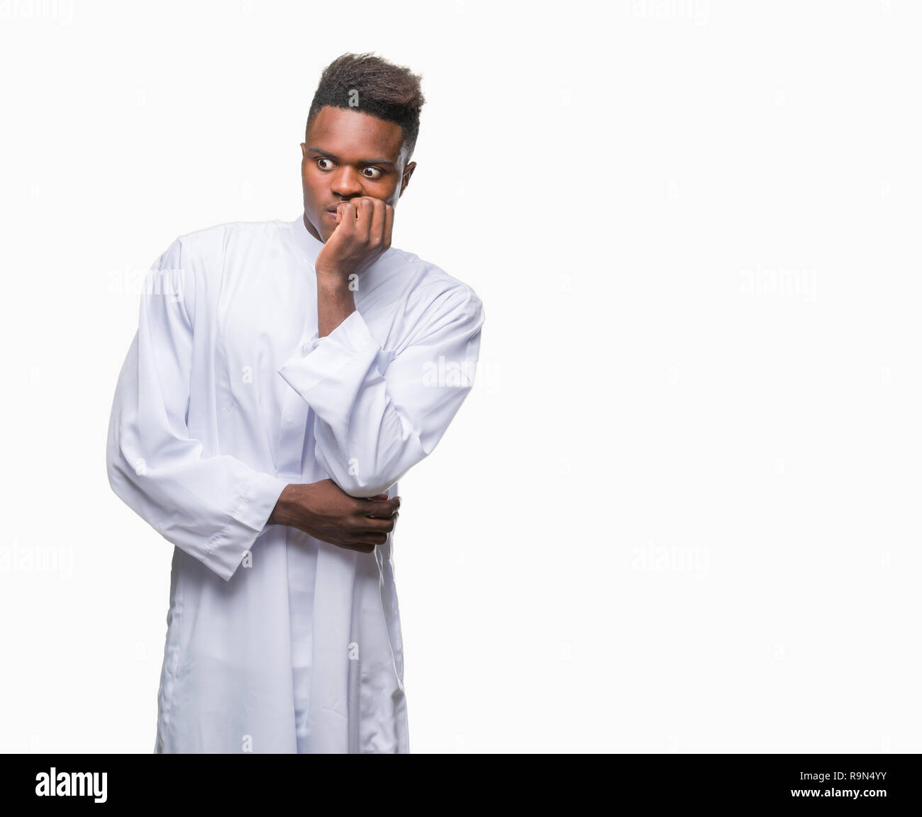 Young arabic african man wearing traditional djellaba over isolated ...