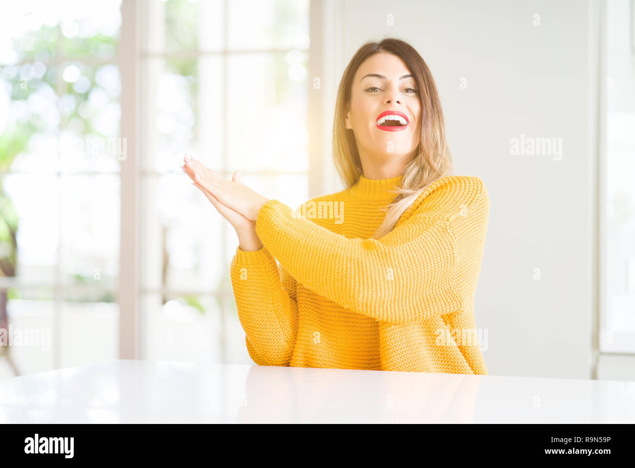 Attractive young woman clapping hands hi-res stock photography and ...