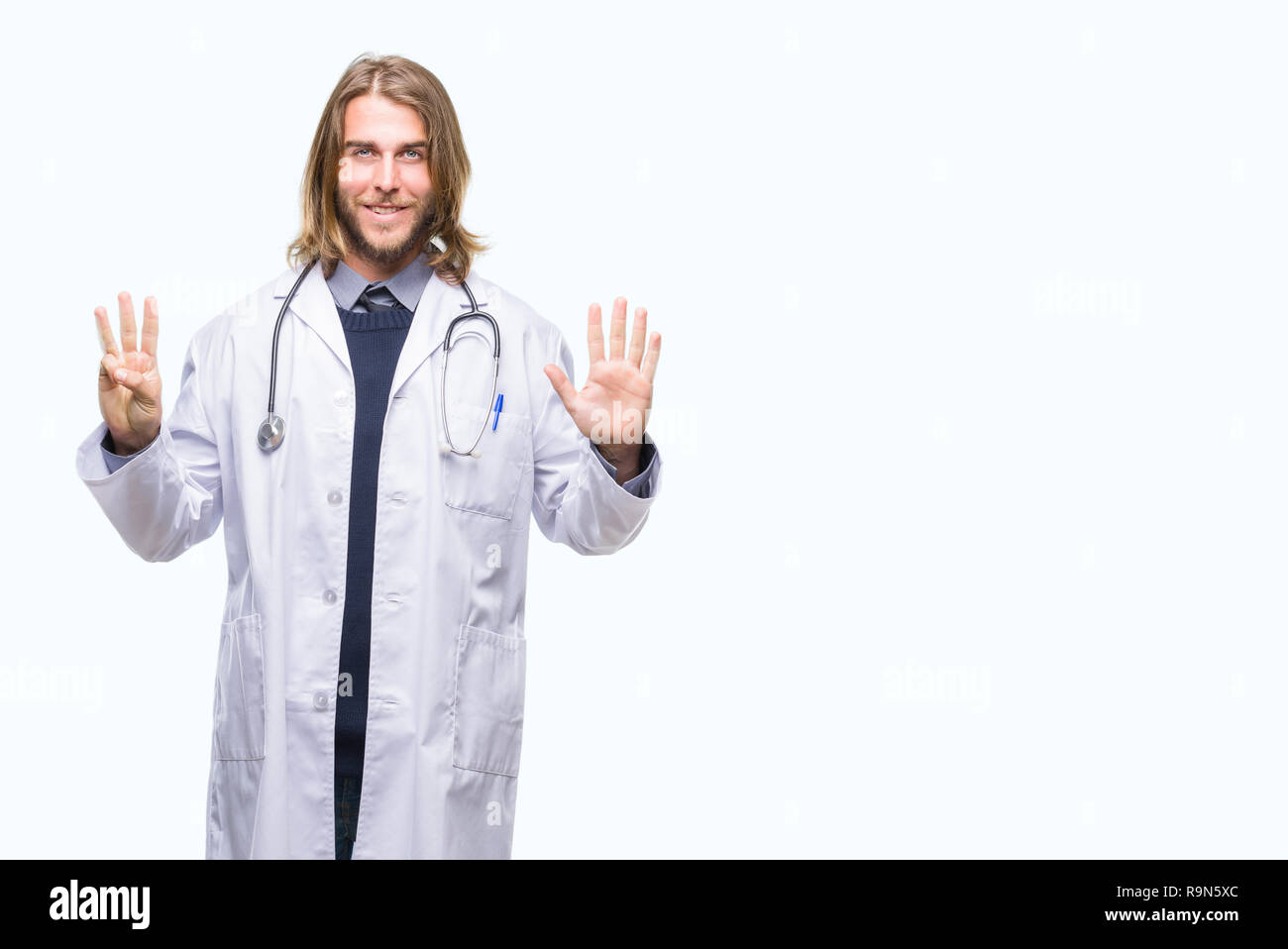 Young handsome doctor man with long hair over isolated background ...