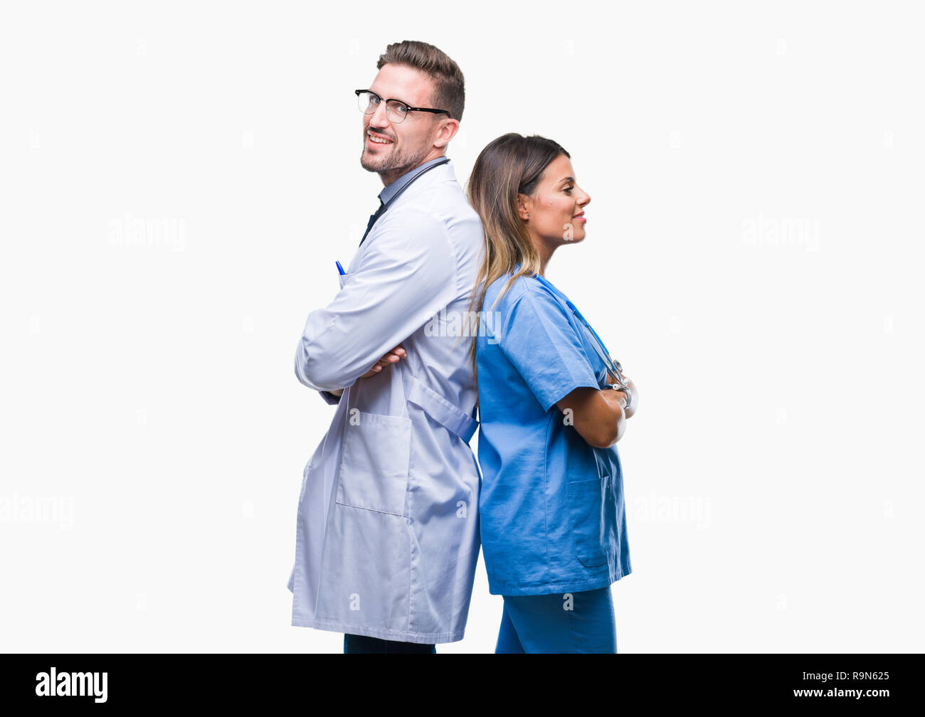Young couple of doctor and surgeon over isolated background happy face ...