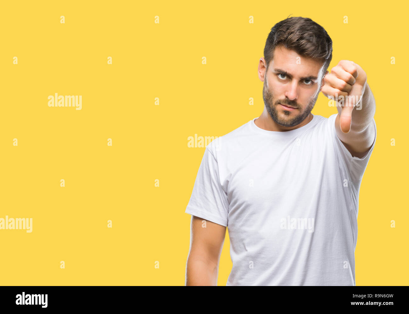 Young handsome man over isolated background looking unhappy and angry ...