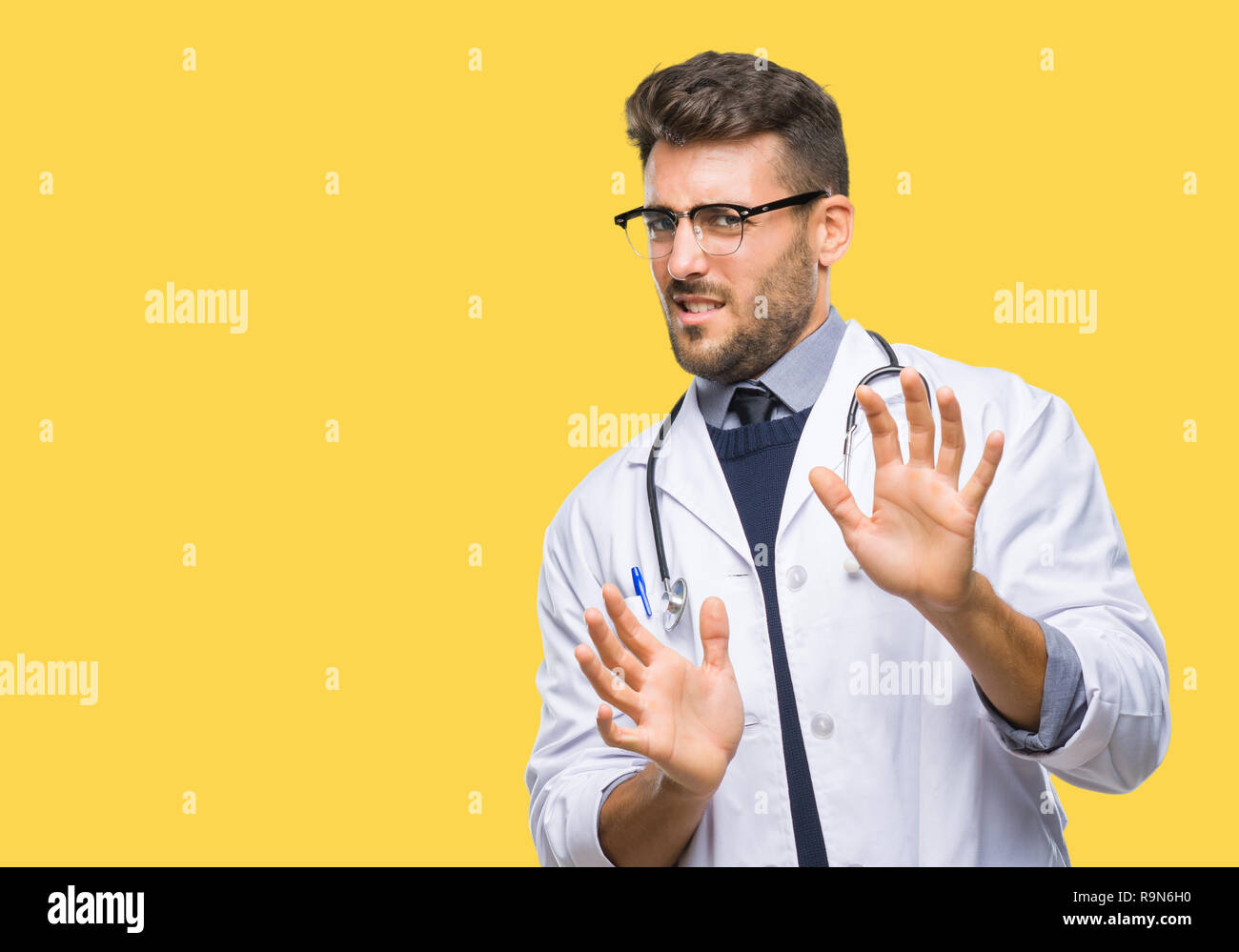 Young handsome doctor man over isolated background disgusted expression ...