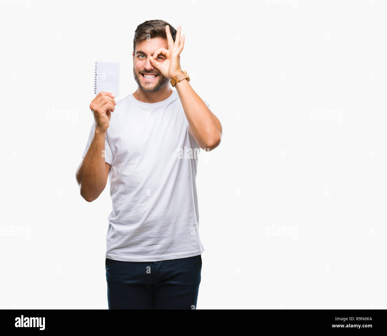 Young handsome man holding notebook over isolated background with happy ...