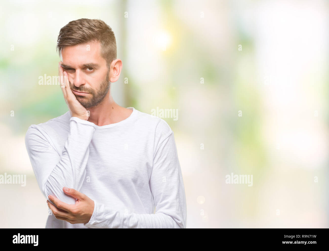 Young handsome man over isolated background thinking looking tired and ...