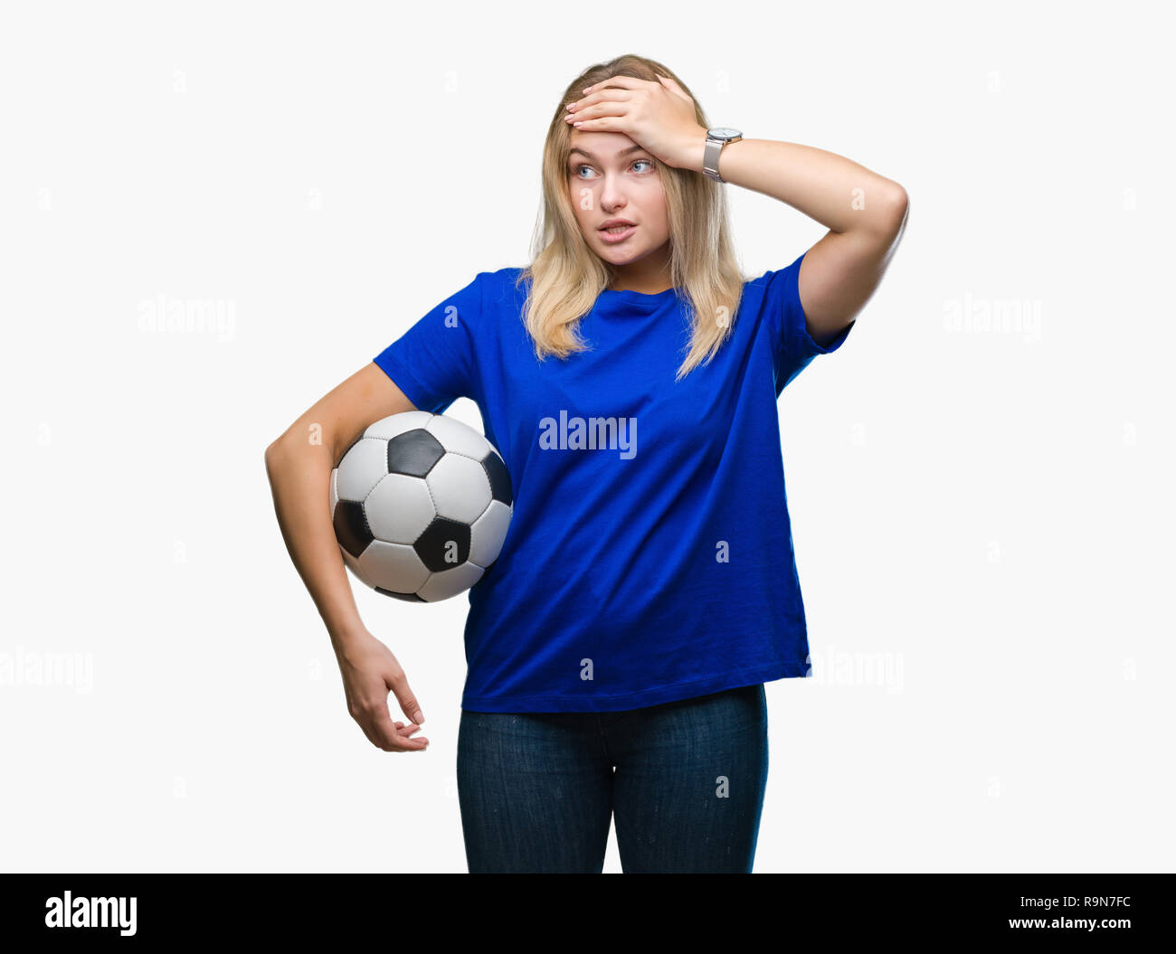 Young caucasian woman holding soccer ball over isolated background ...