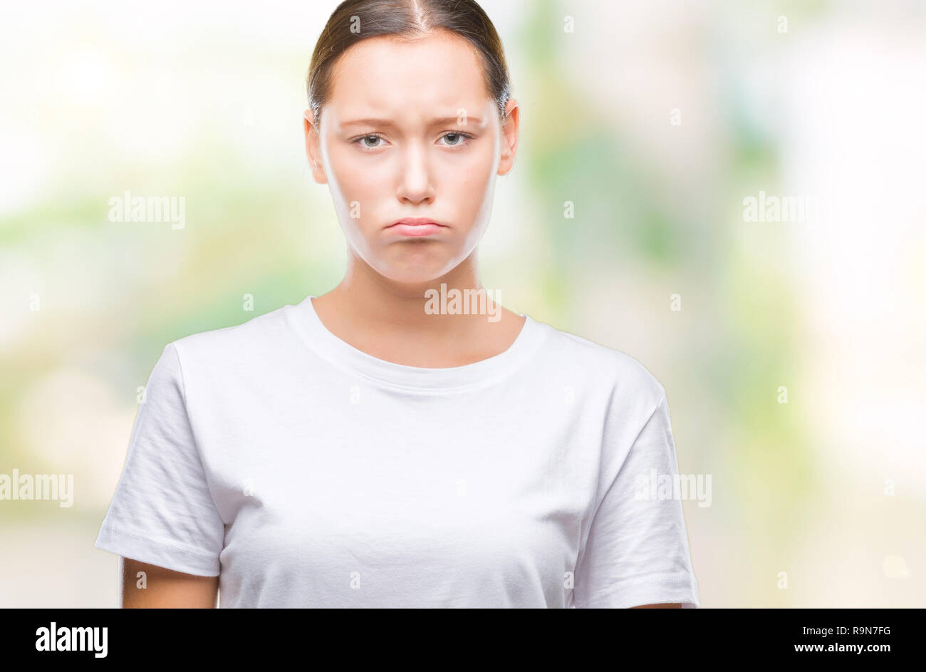 Young beautiful caucasian woman over isolated background depressed and ...