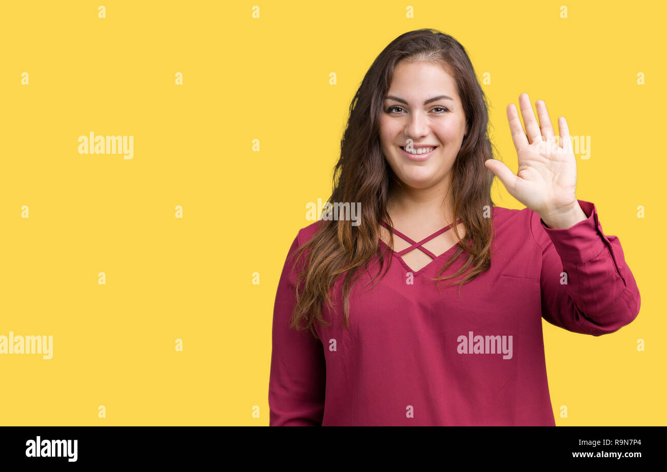Beautiful plus size young woman over isolated background Waiving saying ...