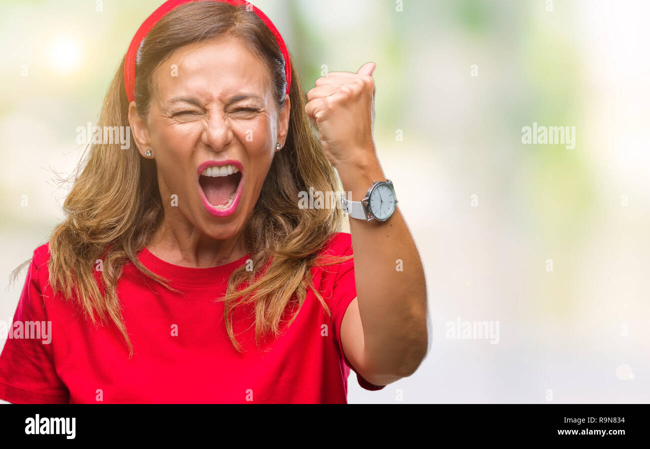 Middle age senior hispanic woman over isolated background angry and mad ...