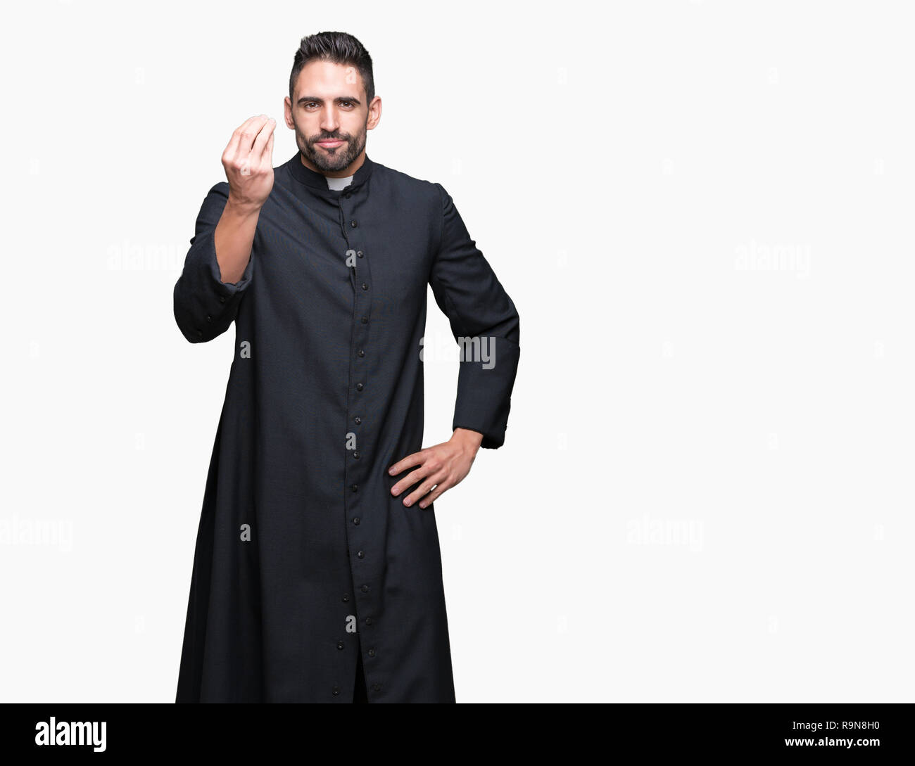Young Christian priest over isolated background Doing Italian gesture ...