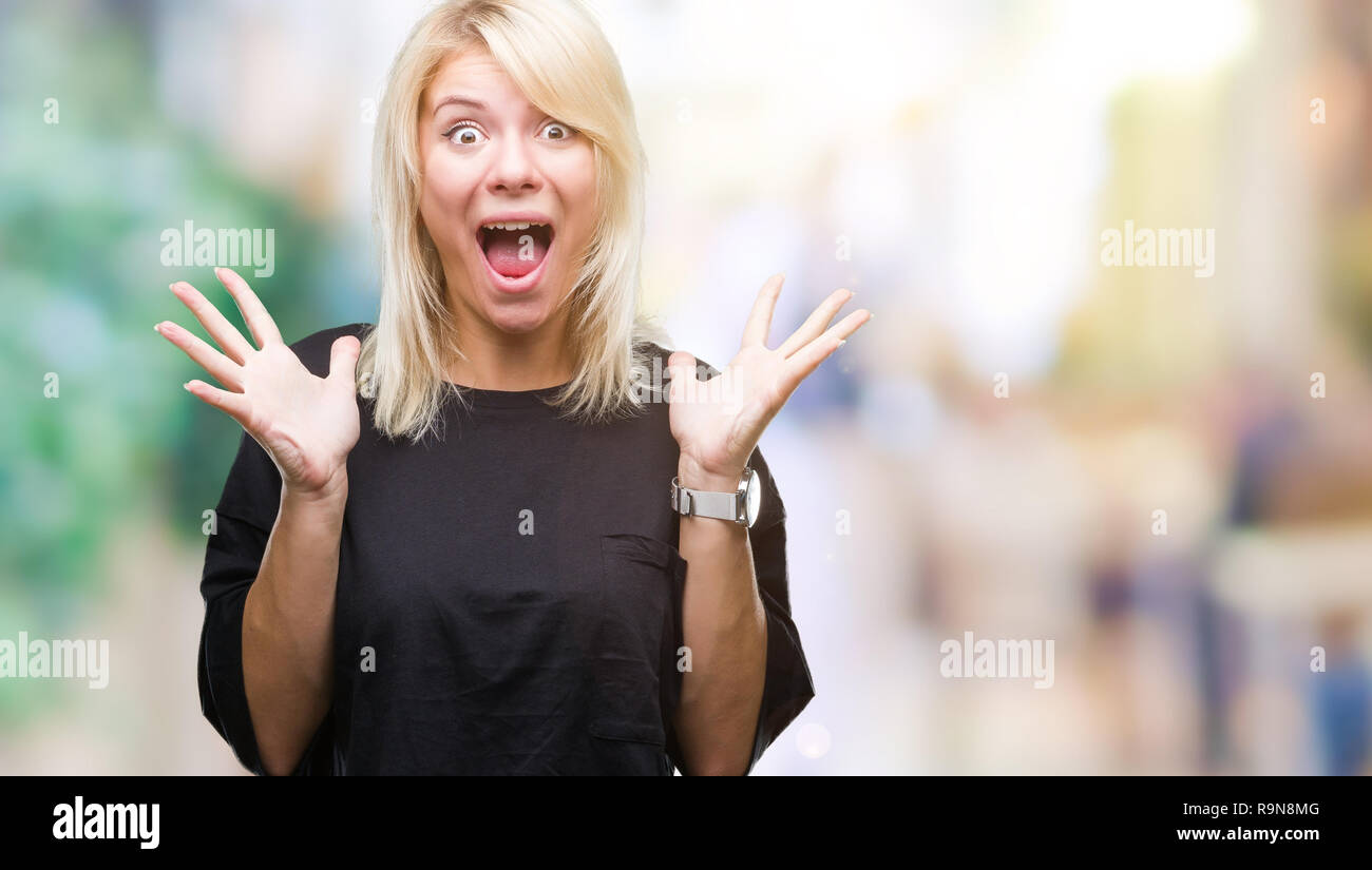 Young beautiful blonde woman over isolated background celebrating crazy ...