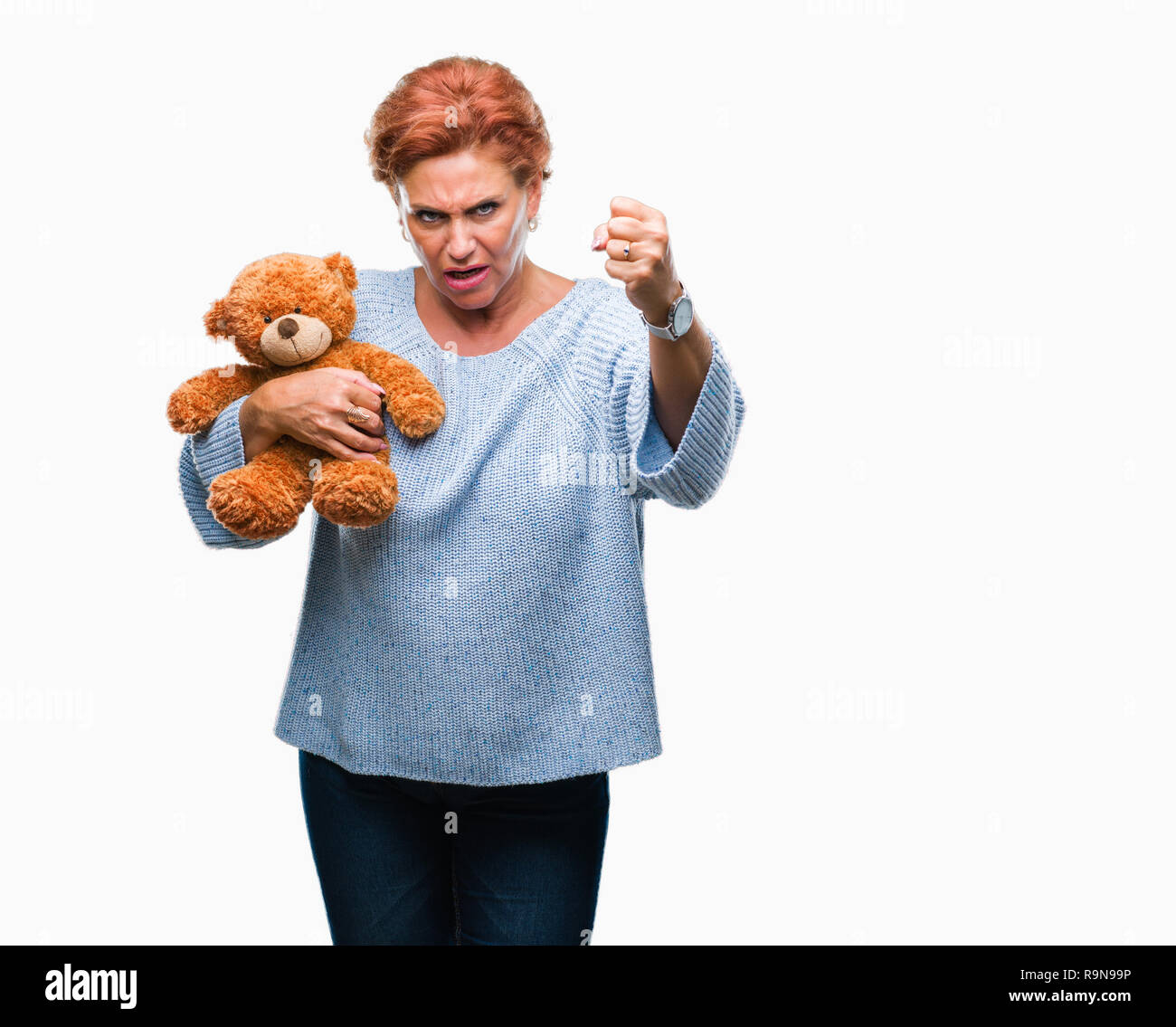 Senior caucasian woman holding teddy bear over isolated background ...