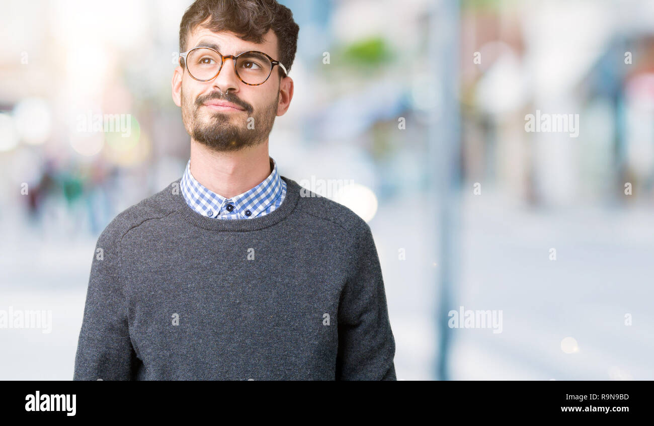 Young handsome smart man wearing glasses over isolated background ...