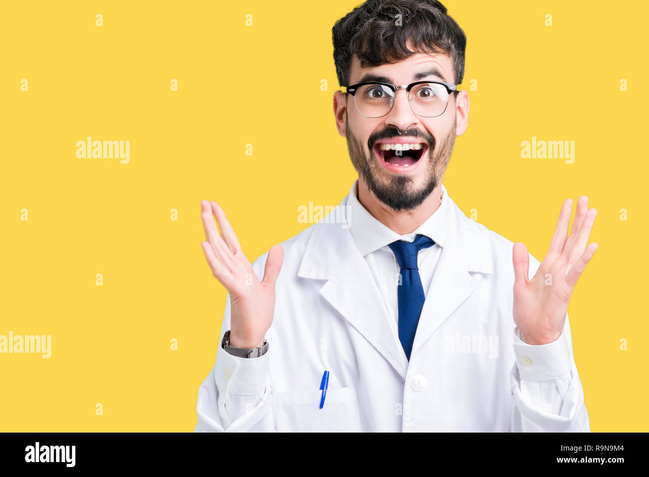 Young professional scientist man wearing white coat over isolated ...
