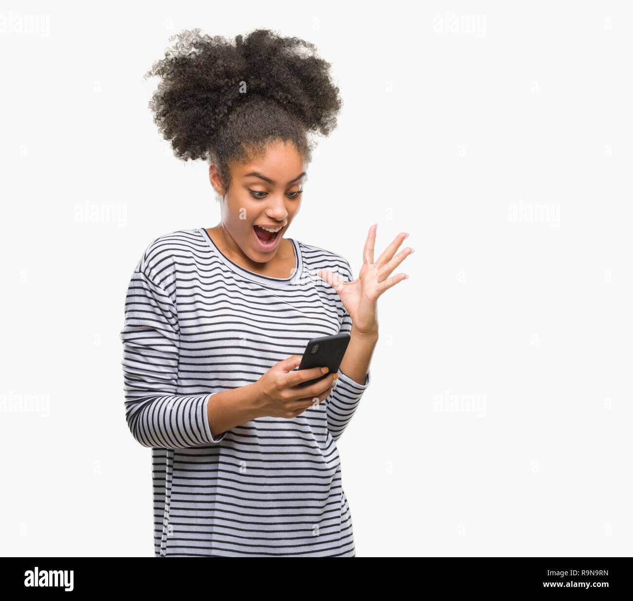 Young afro american woman texting using smartphone over isolated ...