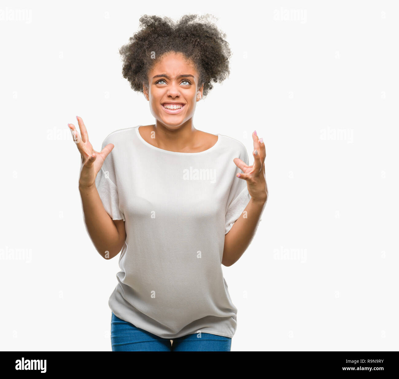 Young afro american woman over isolated background crazy and mad ...