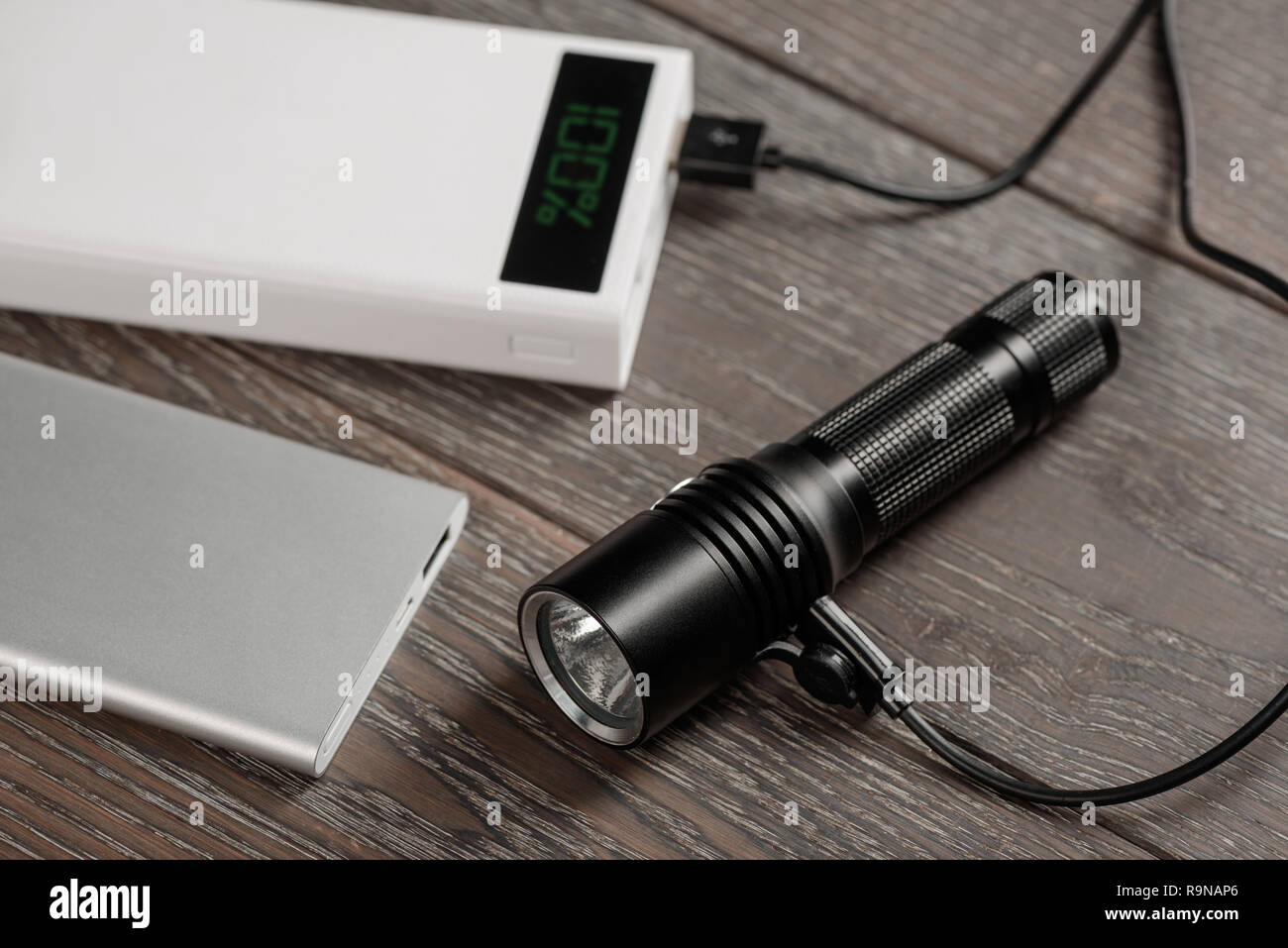 Rechargeable flashlight charging via power Stock Photo - Alamy
