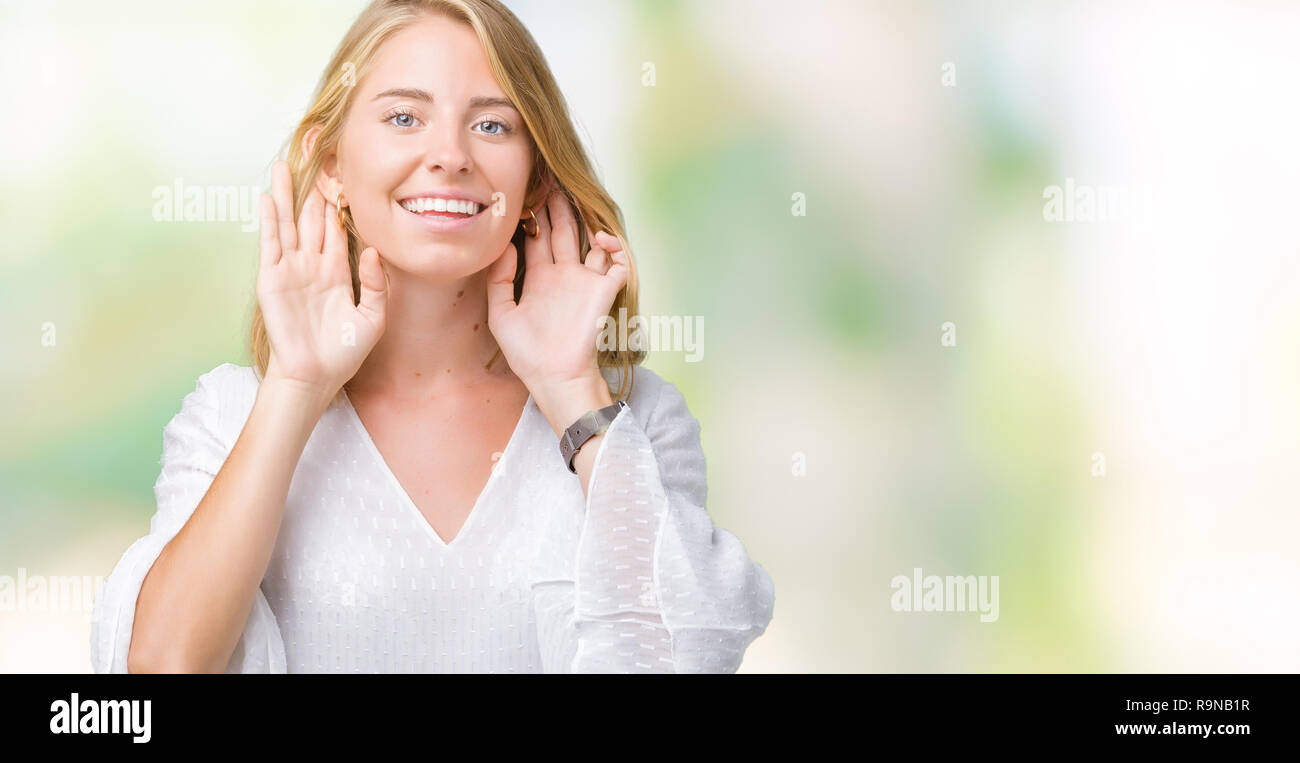 Beautiful young elegant woman over isolated background Trying to hear ...