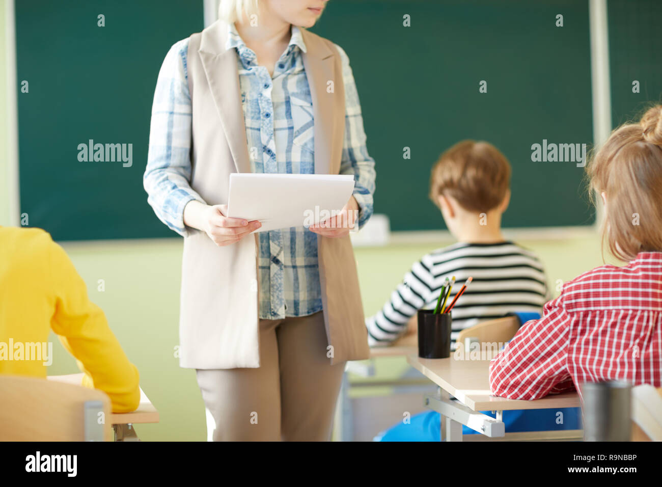 Teacher giving task to pupils Stock Photo - Alamy
