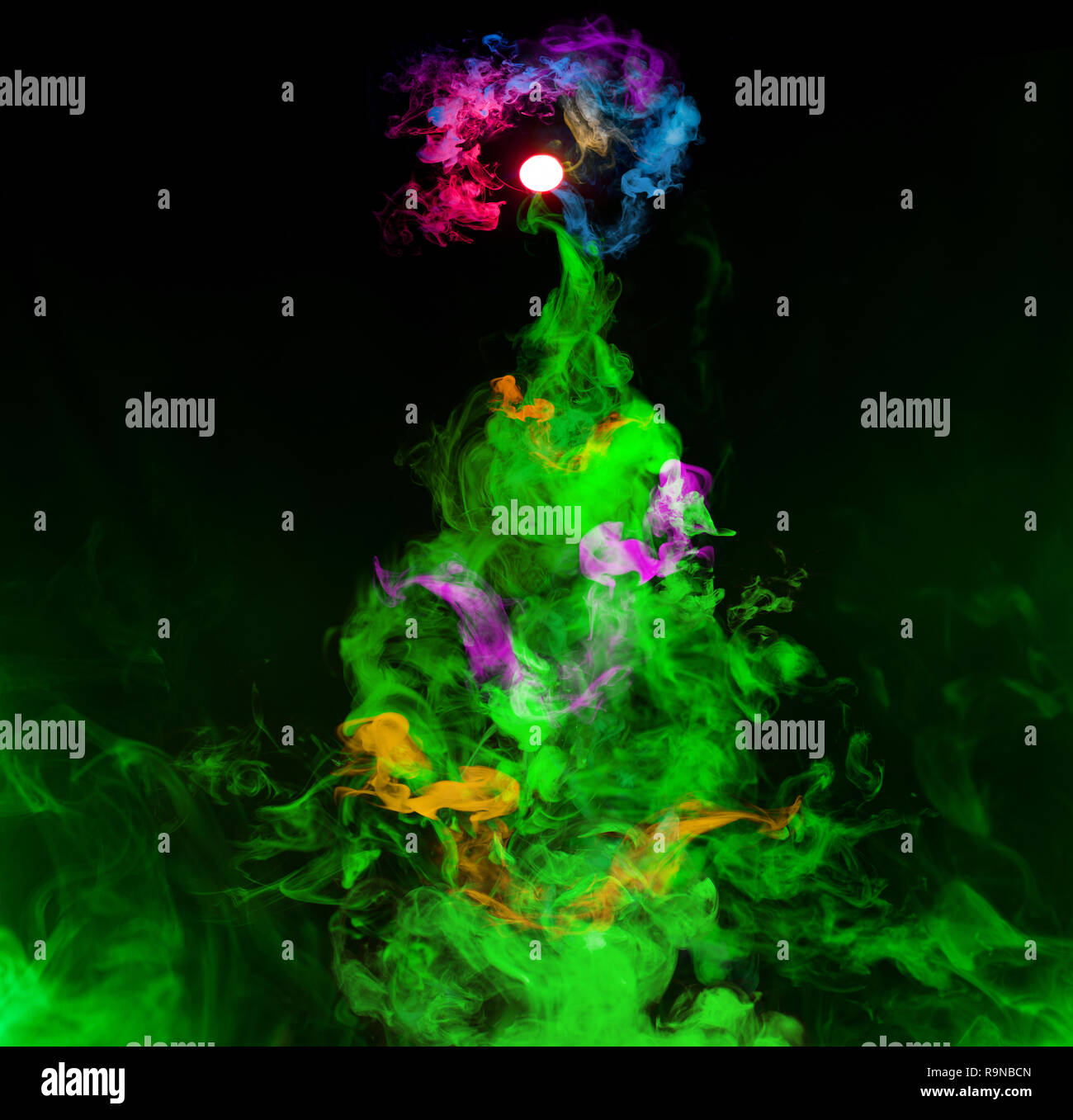 christmas tree from green colorful smoke over black background Stock ...