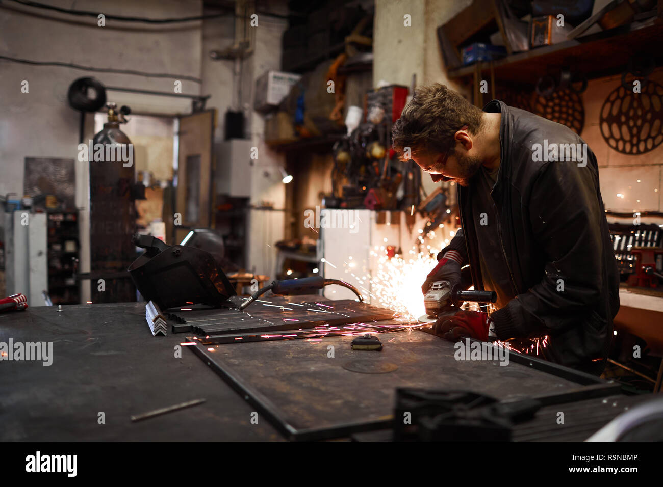 Sanding metal part in smithery Stock Photo - Alamy
