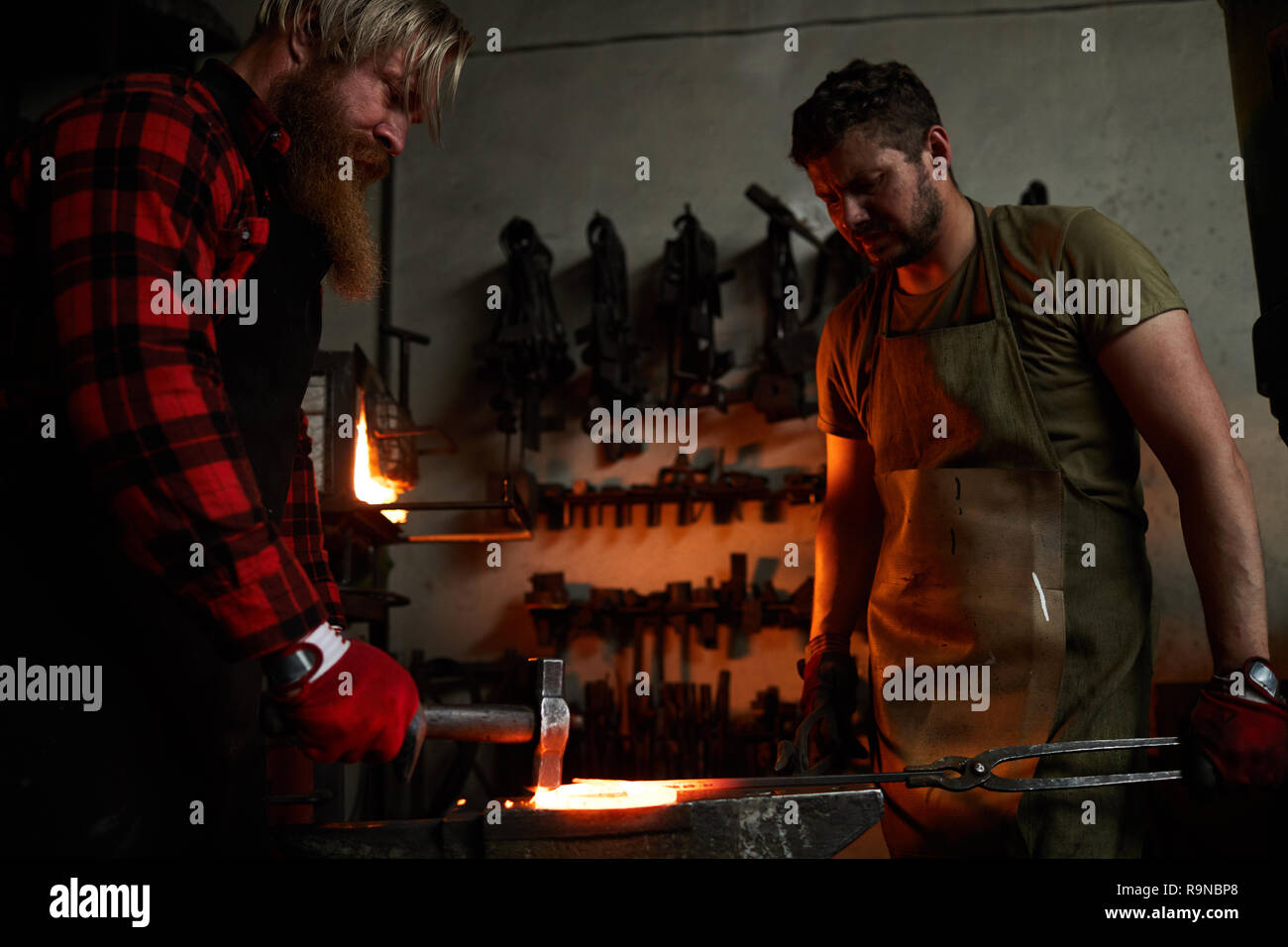 Changing shape of heated metal in smithery Stock Photo - Alamy