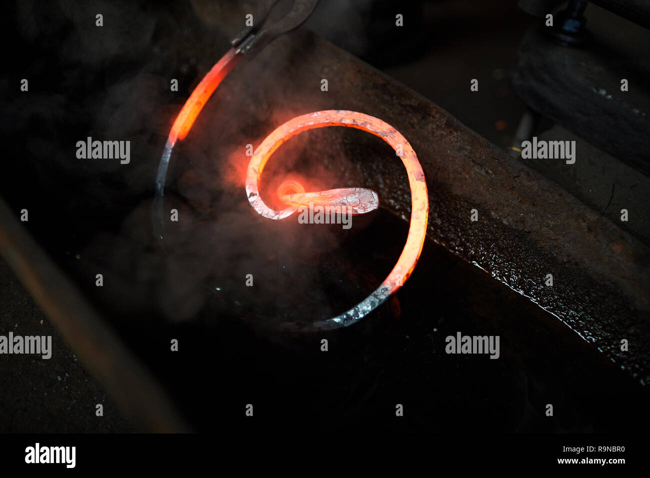 Cooling iron in water Stock Photo - Alamy