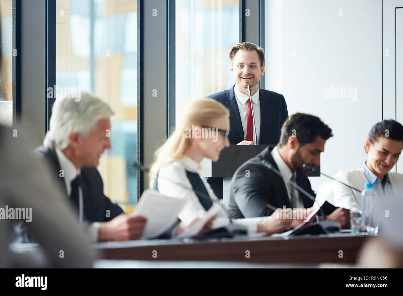 Talking in microphone Stock Photo - Alamy