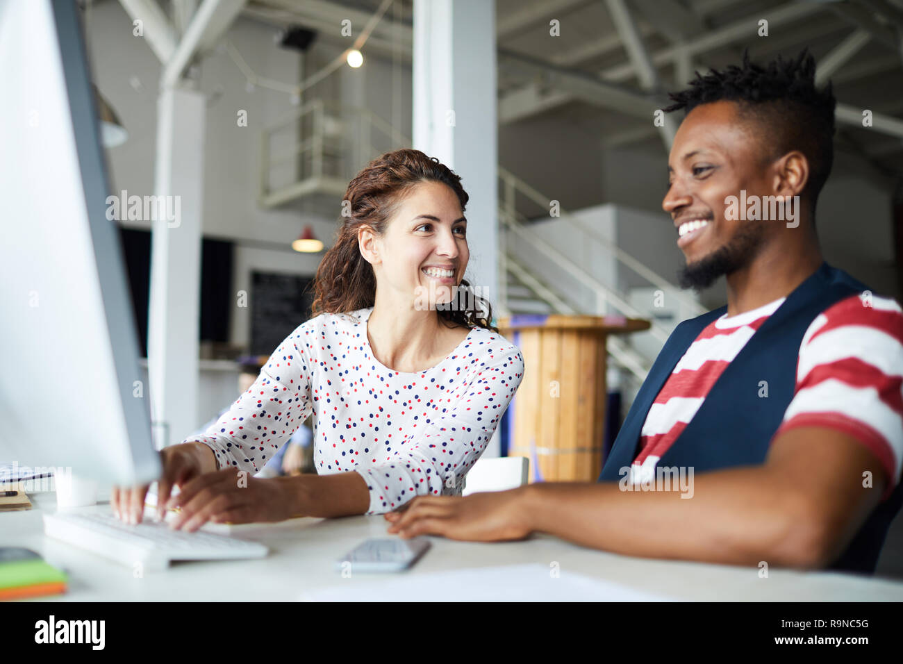 Multiethnic team working on computer hi-res stock photography and ...