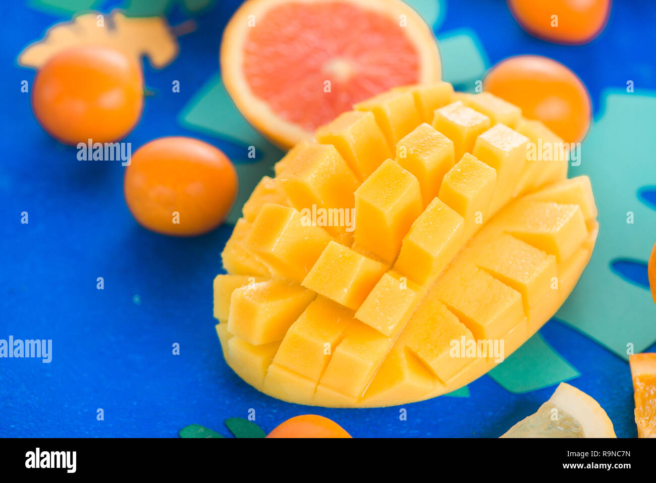 Exotic fruits close-up. Mango, oranges, kumquat and other tropical ...
