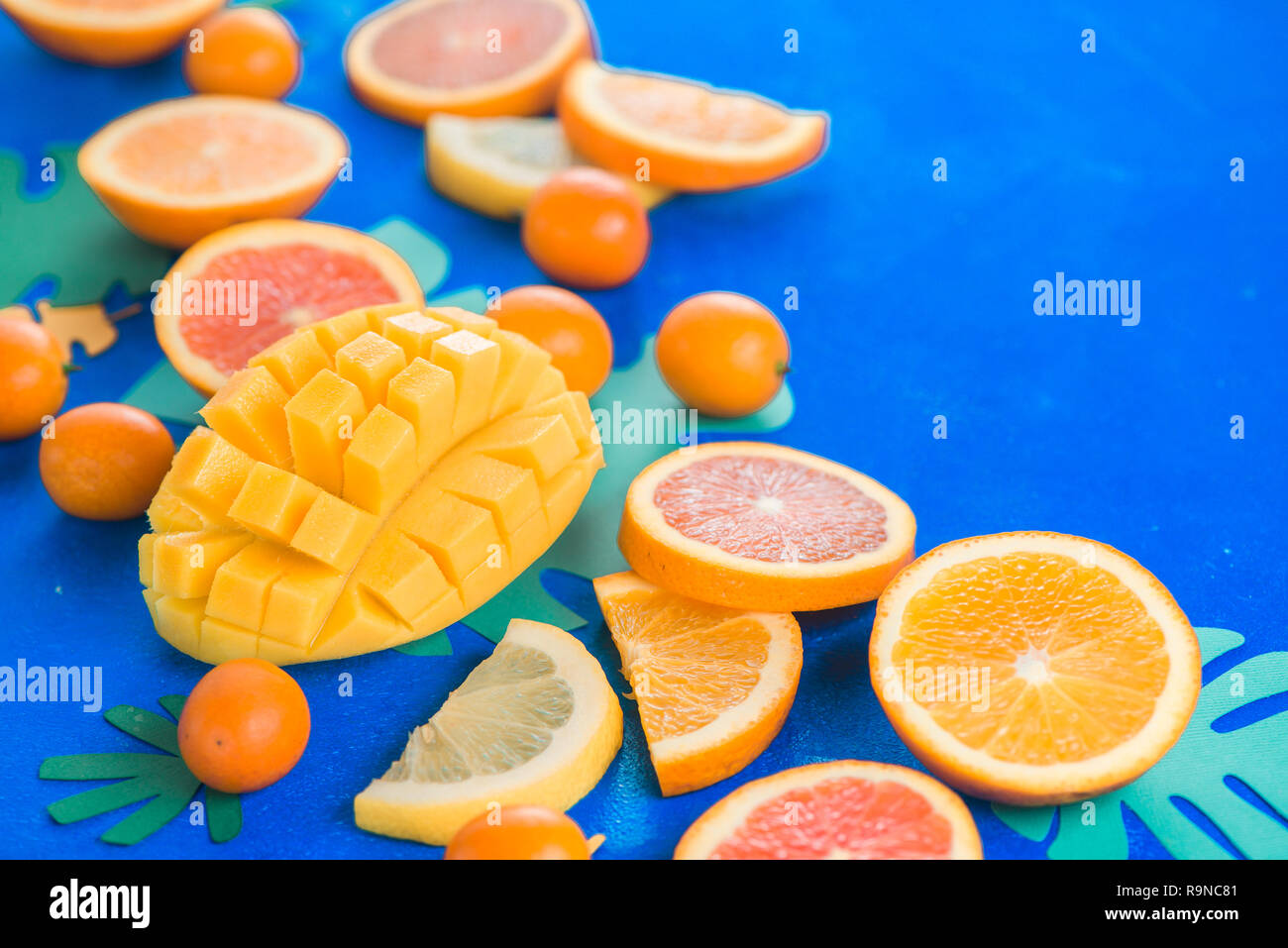 Exotic fruits close-up. Mango, oranges, kumquat and other tropical ...