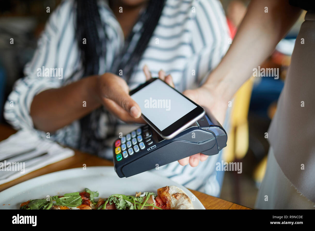 Paying through smartphone Stock Photo - Alamy