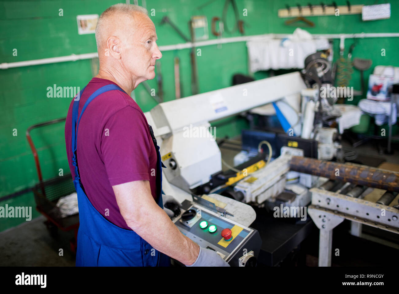 Operator standing at machine Stock Photo - Alamy