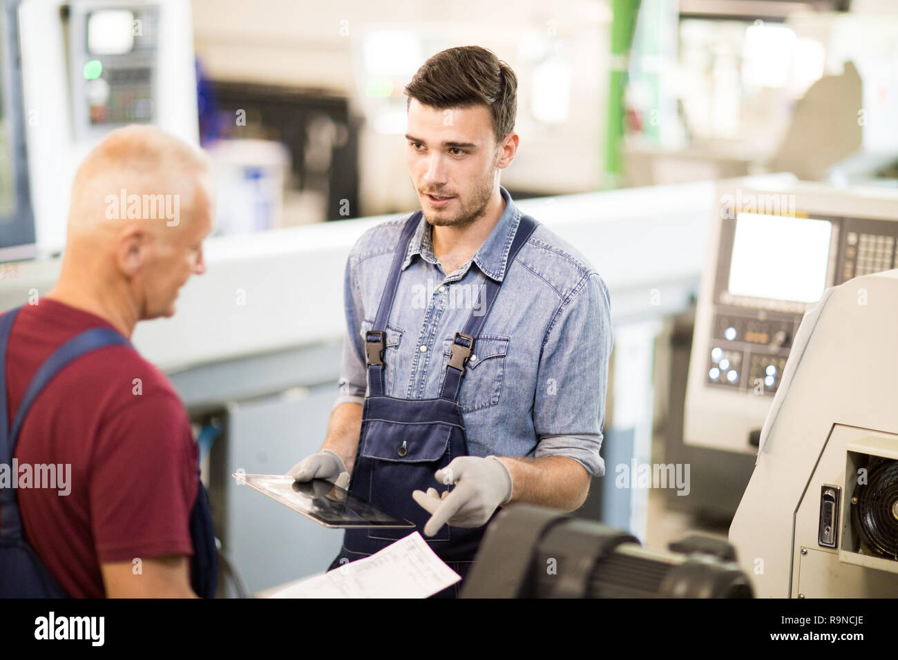 Working in team at industrial factory Stock Photo - Alamy
