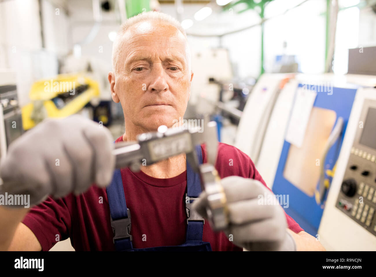 Worker with instrument at work Stock Photo - Alamy