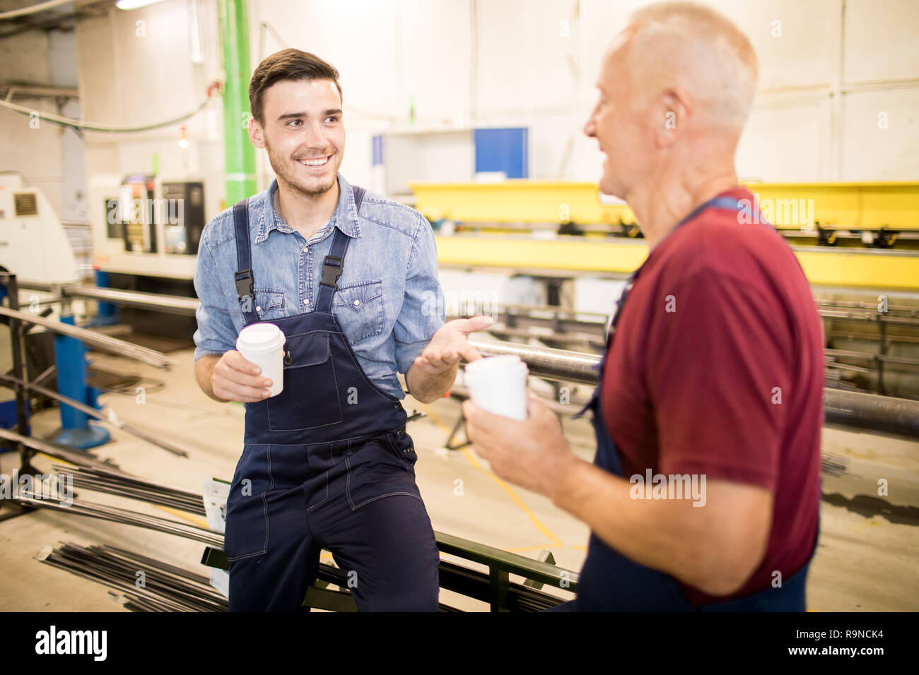 Workers taking break in factory Stock Photo - Alamy
