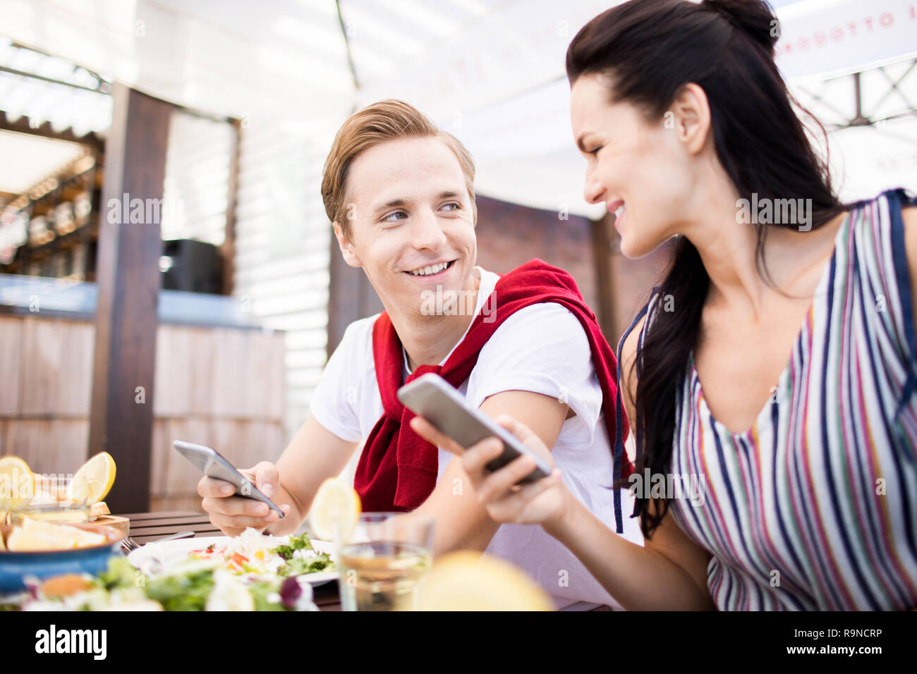Couple table texting hi-res stock photography and images - Alamy