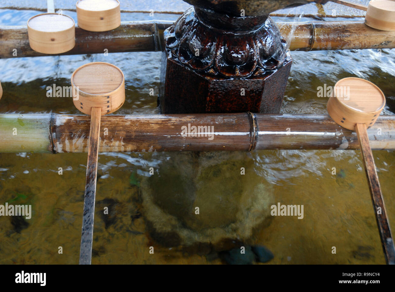 Water fountain and ladles at temple complex in Kyoto, Japan Stock Photo ...