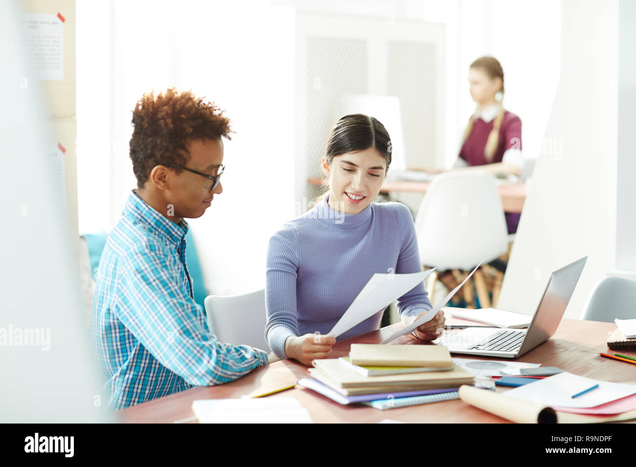 Groupmates in library Stock Photo - Alamy
