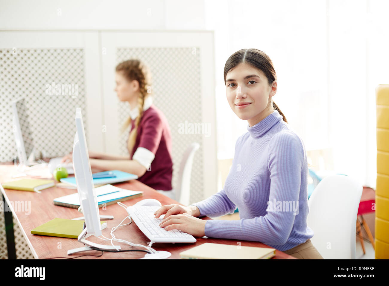 Working by computer Stock Photo - Alamy