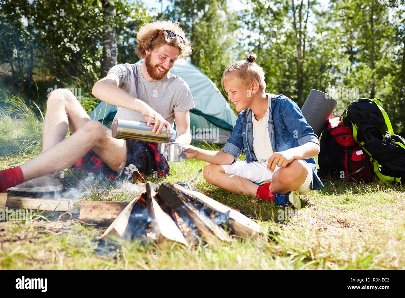 Guys by campfire Stock Photo - Alamy