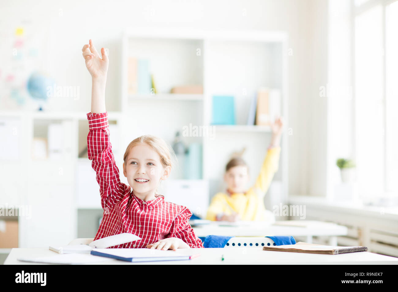 Child raising hand back hi-res stock photography and images - Alamy