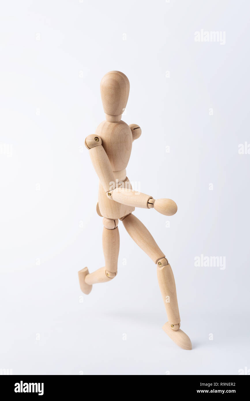 Business and design concept - running wooden mannequin isolated on ...