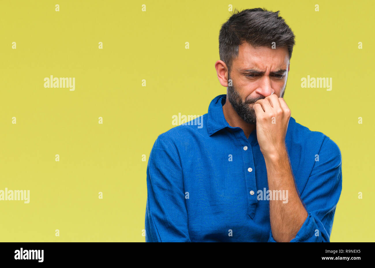 Adult hispanic man over isolated background looking stressed and ...