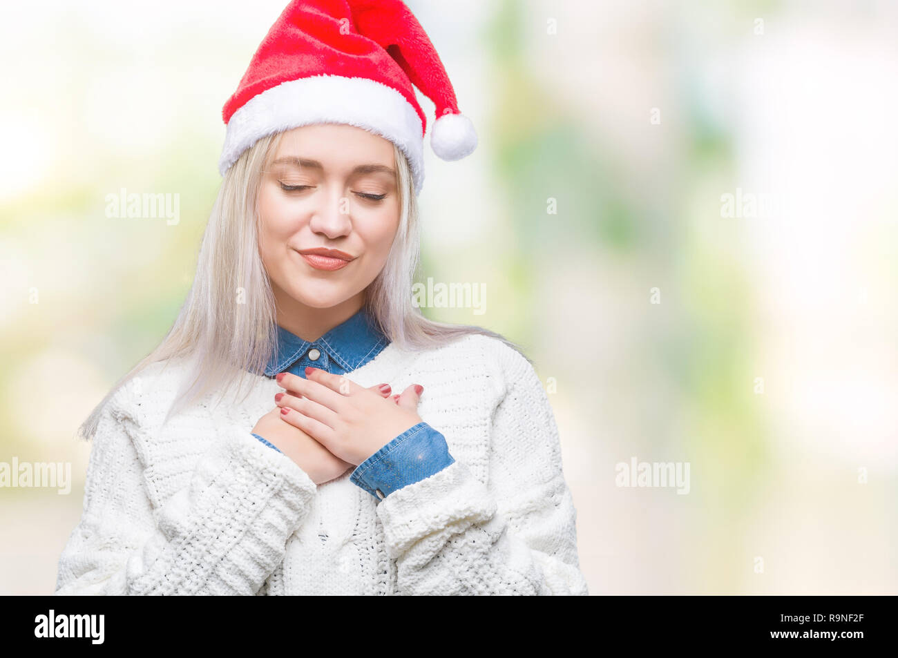 Young Blonde Woman Wearing Christmas Hat Over Isolated Background