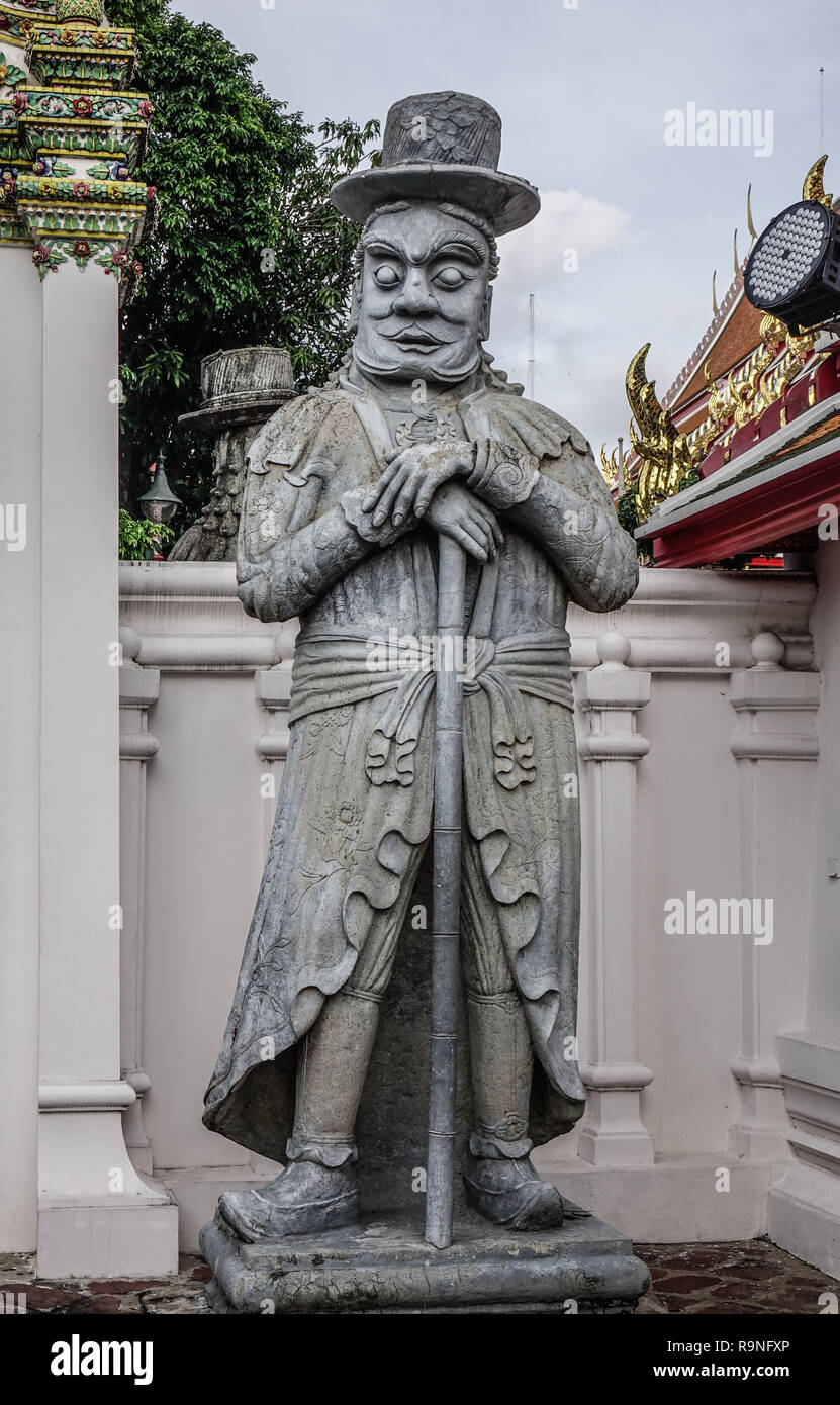Chinese guardian figure beside a gate in Wat Pho. Wat Pho is one of the ...