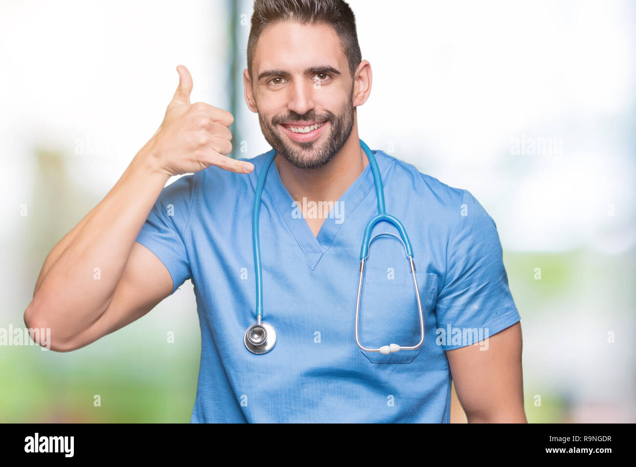 Handsome young doctor surgeon man over isolated background smiling ...