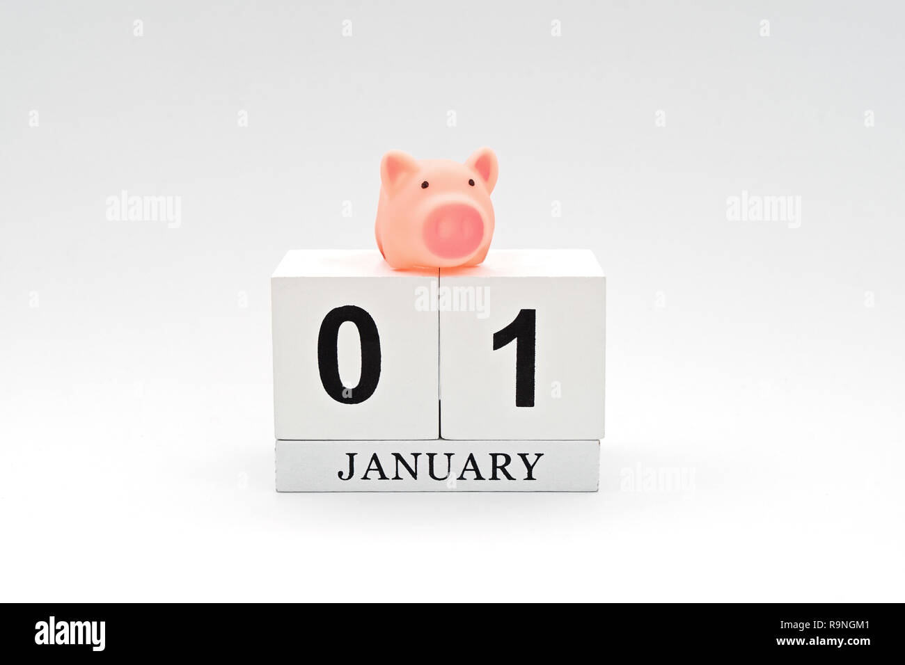 1st January is first day of new year. Cute little piggy on wooden ...