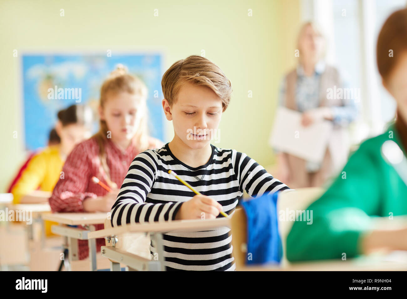 Boy writing exam test Stock Photo - Alamy